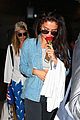 Selena Gomez Smells The Roses at LAX Airport with Cara Delevingne ...