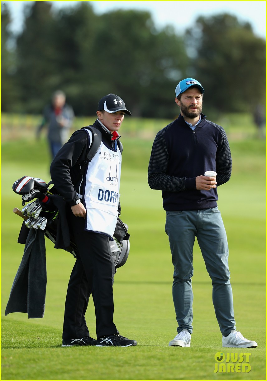 Jamie Dornan Hits Out of the Bunker During Day Three of Golf Tournament ...