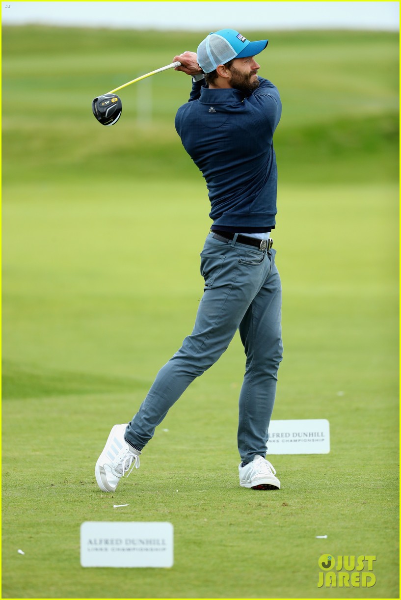 Jamie Dornan Hits Out of the Bunker During Day Three of Golf Tournament ...