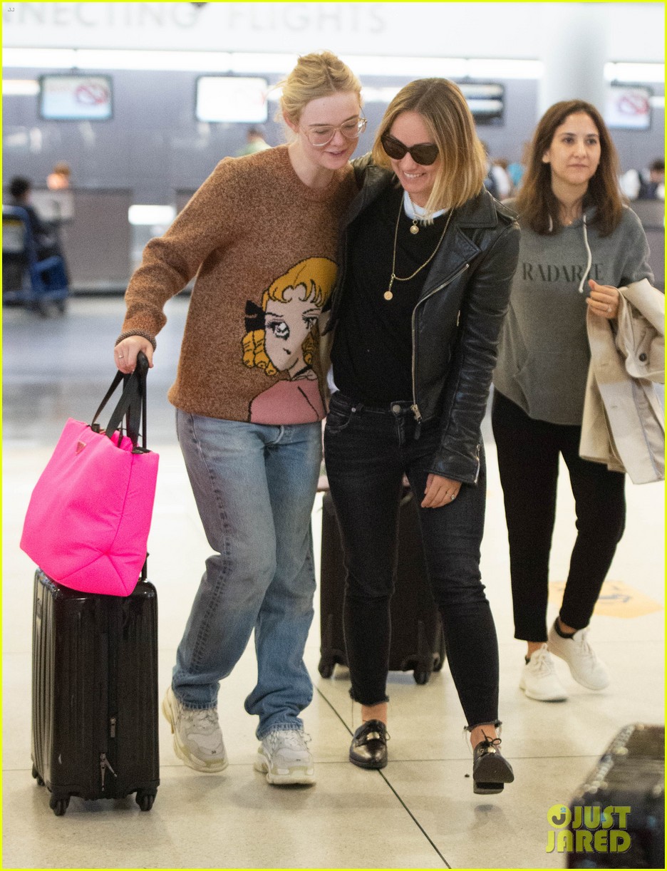 Elle Fanning & Olivia Wilde Share a Laugh at JFK Airport With Jason ...