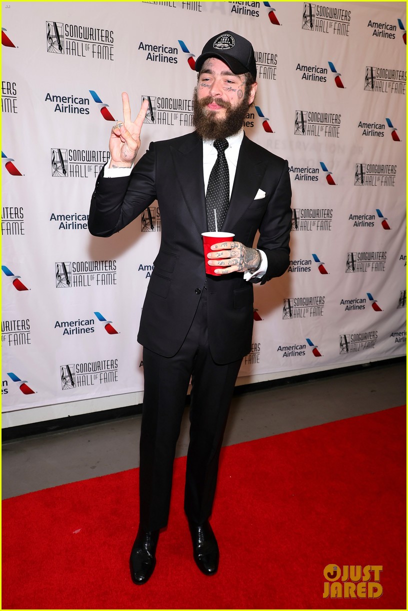 Post Malone Suits Up, Arrives With a Drink in Hand for Songwriters Hall ...