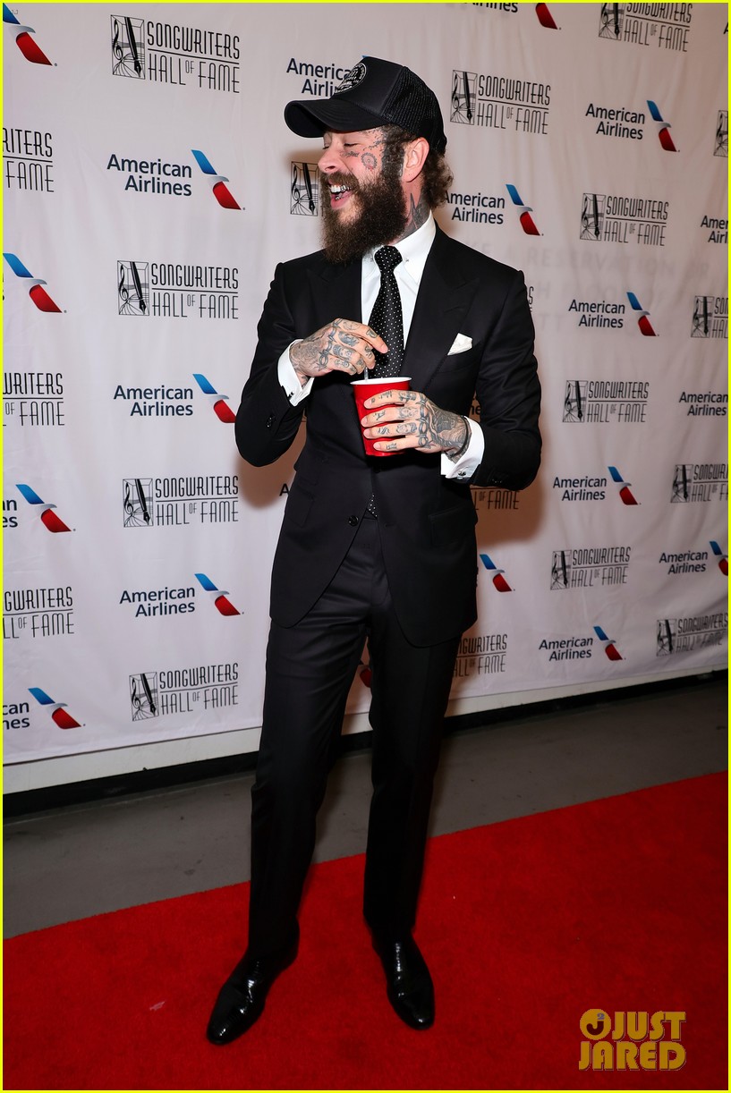 Post Malone Suits Up, Arrives With a Drink in Hand for Songwriters Hall ...