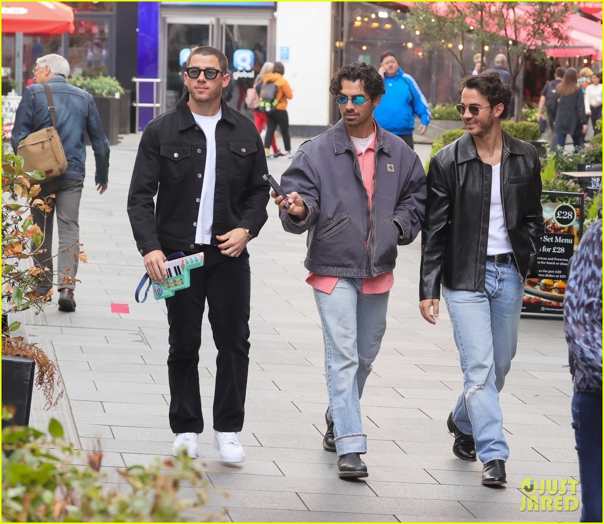 Nick Jonas Carries a Toy Musical Instrument During Outing With Brothers ...