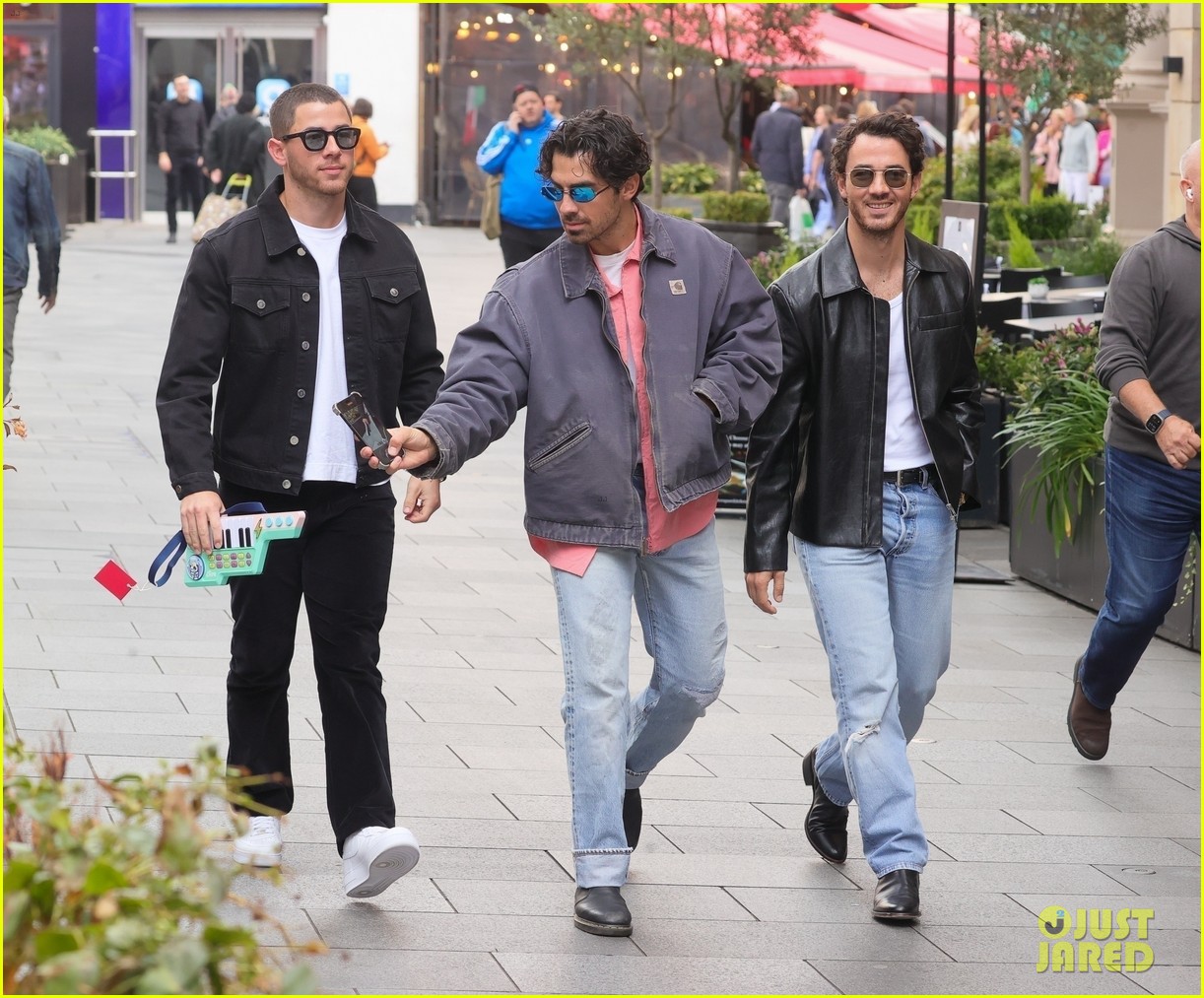 Nick Jonas Carries a Toy Musical Instrument During Outing With Brothers ...